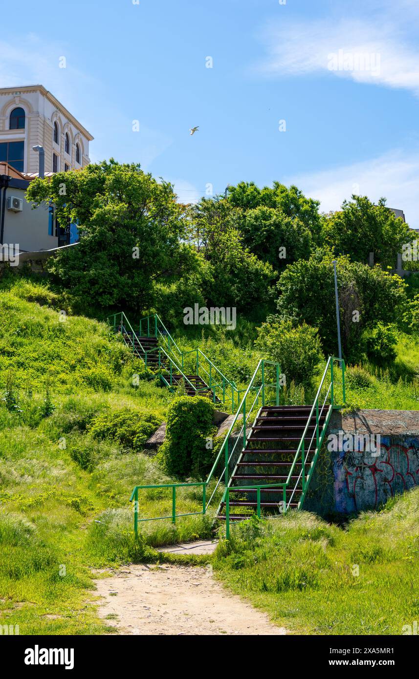 Green stairs leading to small hilltop building Stock Photo - Alamy