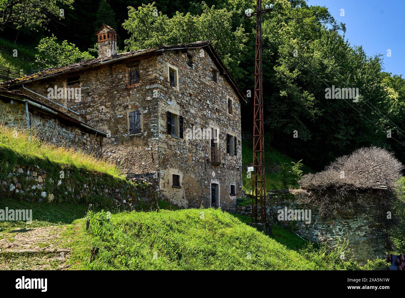 An ancient stone house on a hill, encircled by trees Stock Photo - Alamy