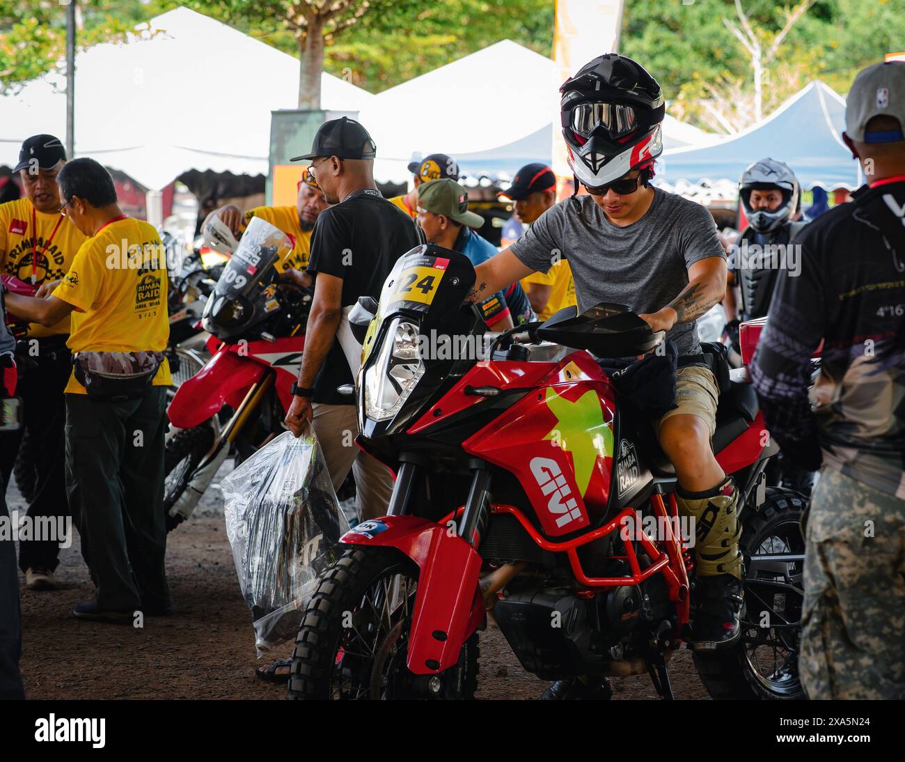 Enduro motorcyclists check their vehicles during practice Stock Photo ...