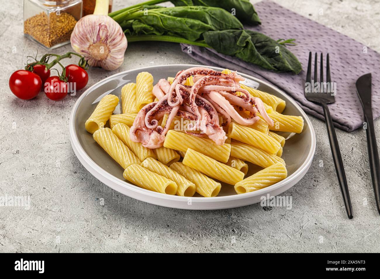 Italian cuisine - pasta tortiglioni with squid tentacles Stock Photo ...