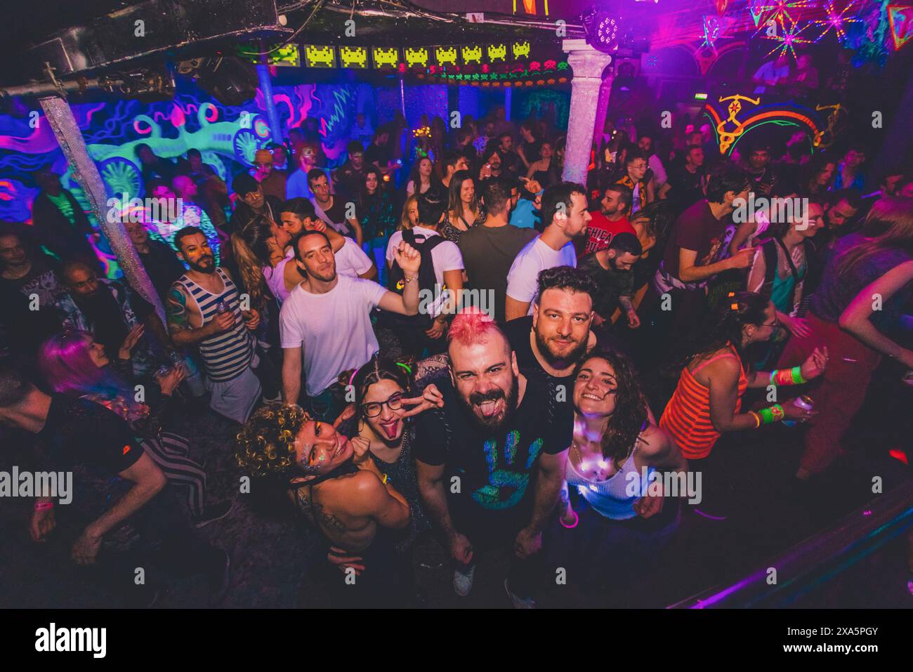 A vibrant nightlife scene in Bristol with people dancing under neon ...