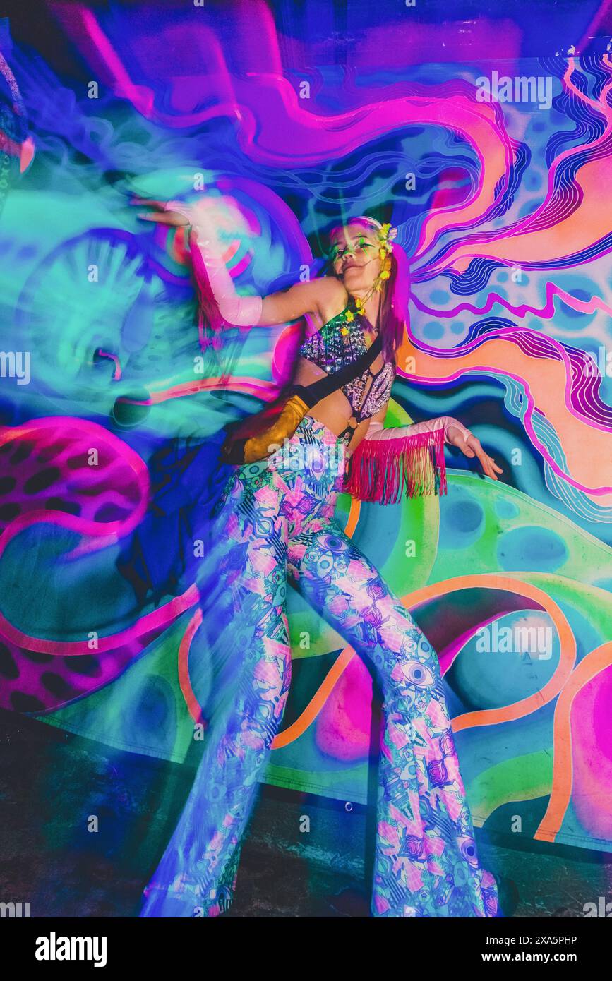 A vibrant nightlife scene in Bristol with a woman dancing under neon ...