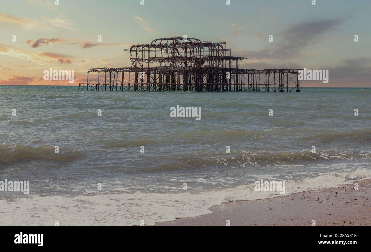 A sunset over Brighton's historic pier Stock Photo - Alamy
