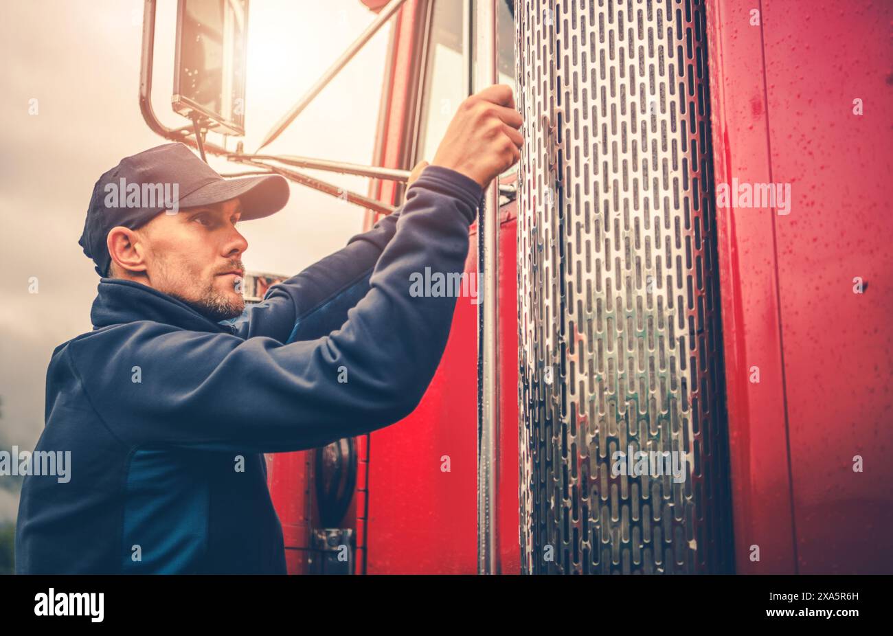 A Caucasian Commercial Truck Driver and His Red Semi Truck Stock Photo ...