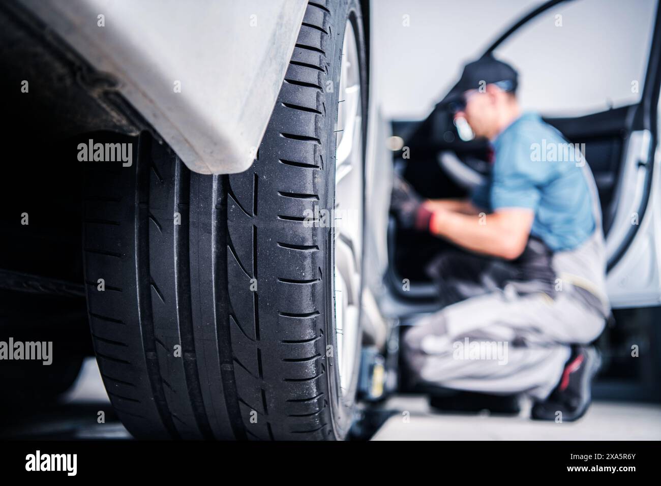 A mechanic fixing a car Under Maintenance in a Certified Auto Service ...