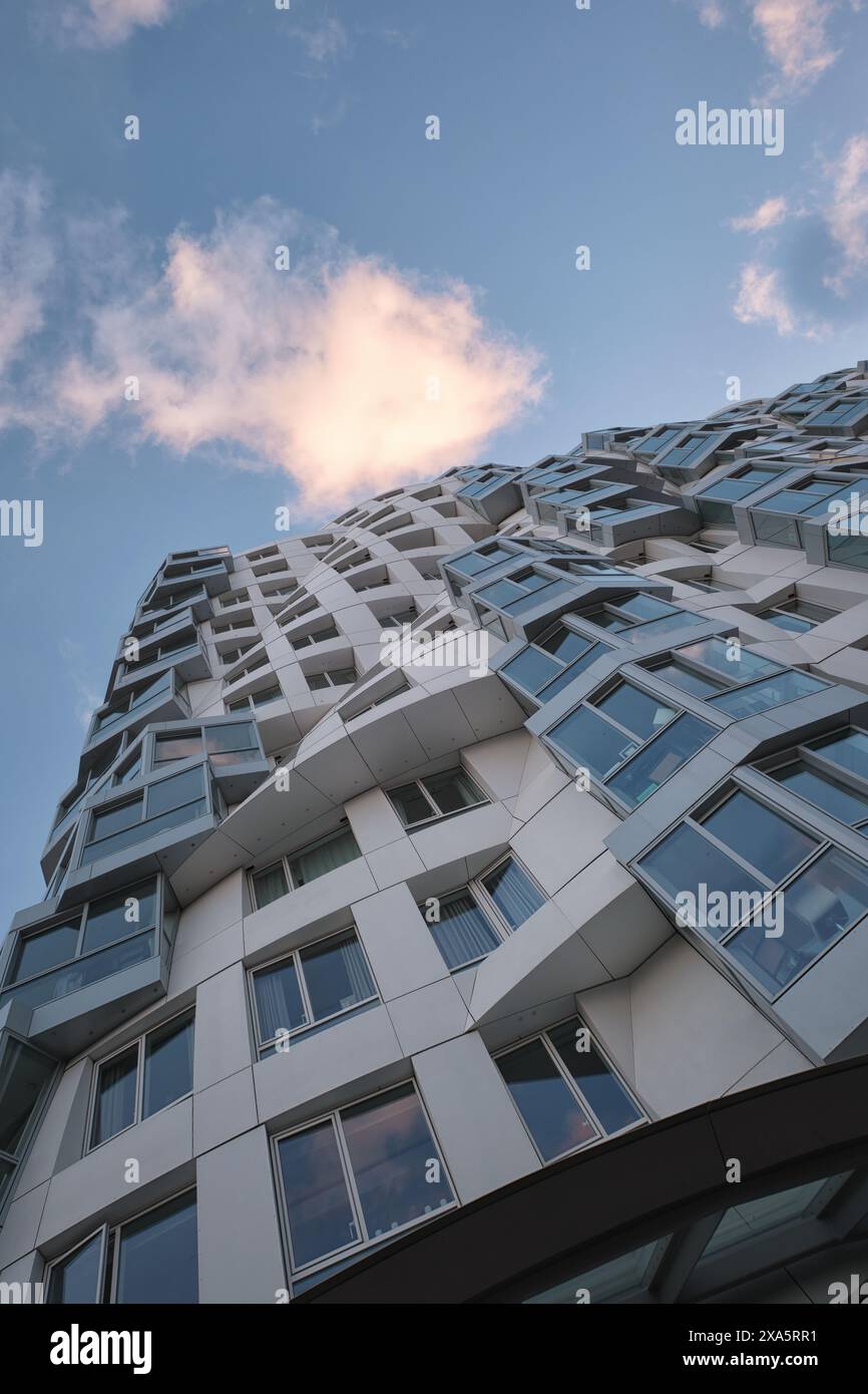 A tall building with reflective windows catching light Stock Photo - Alamy