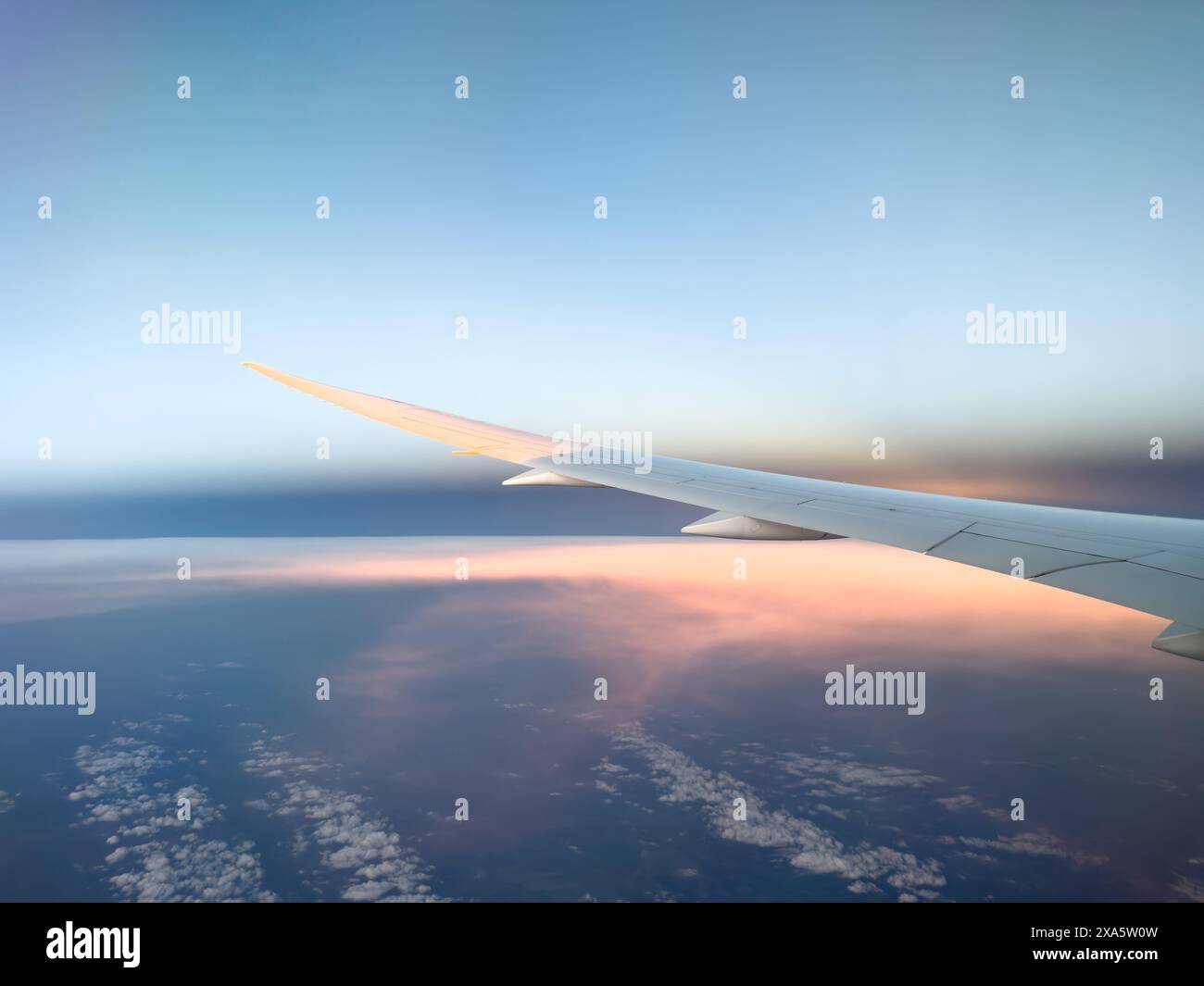 Last light at sunset on the wingtip of a Boeing 787-8, approaching ...