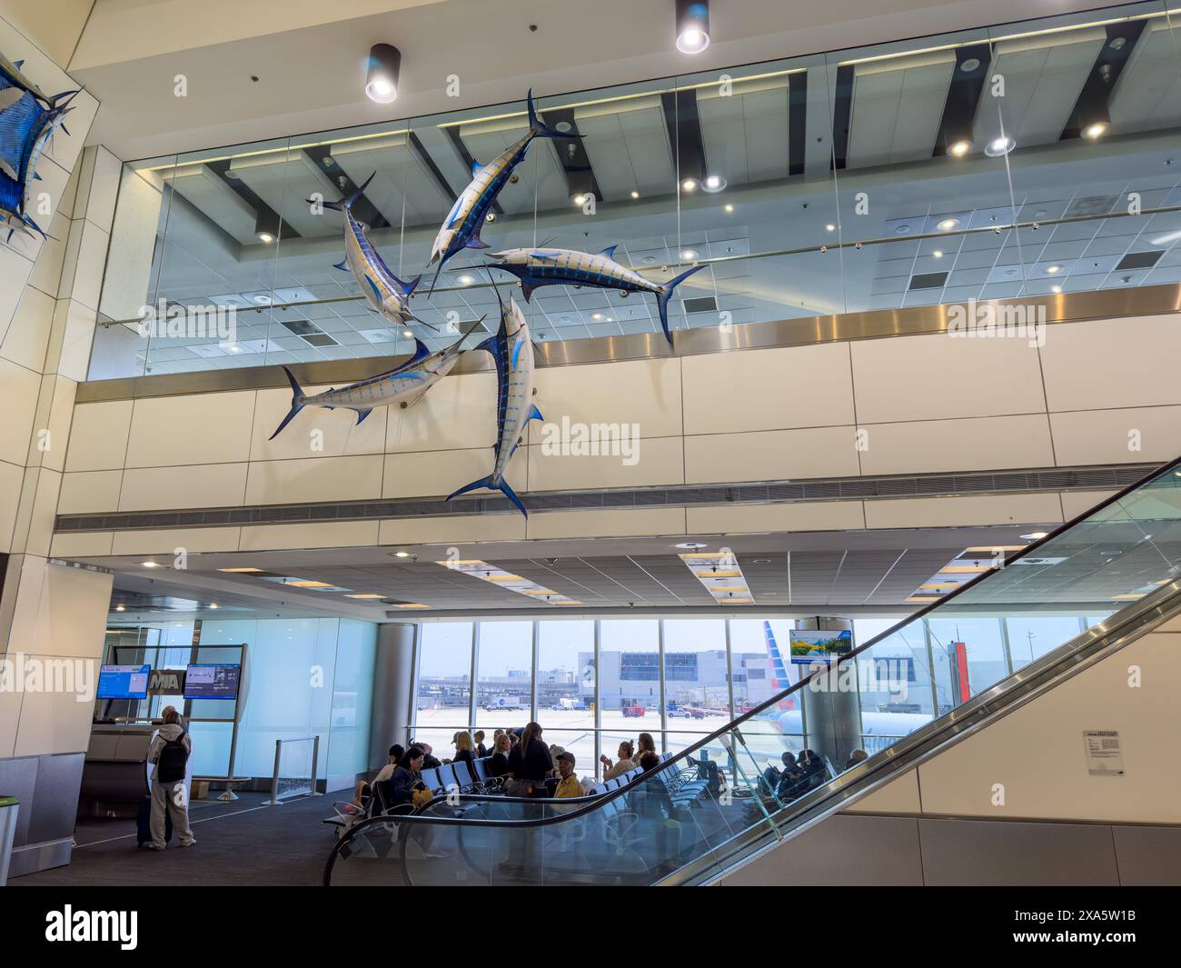 Travelers in the Miami International Airport terminal with its ocean ...