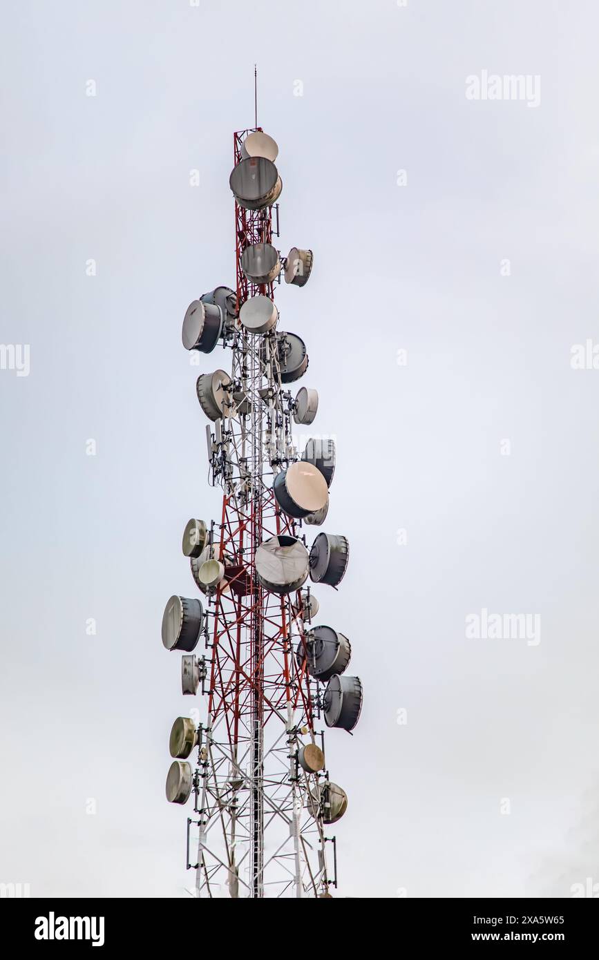 a large radio relay tower with many antenna dishes. 3G communication in ...