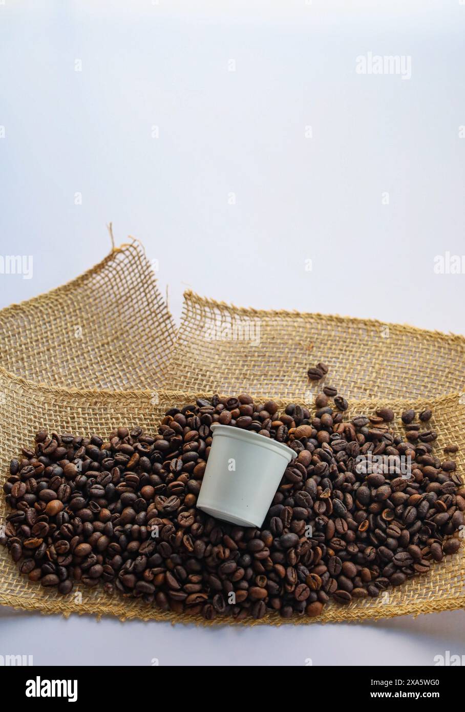 The freshly brewed coffee surrounded by a bed of roasted coffee beans ...