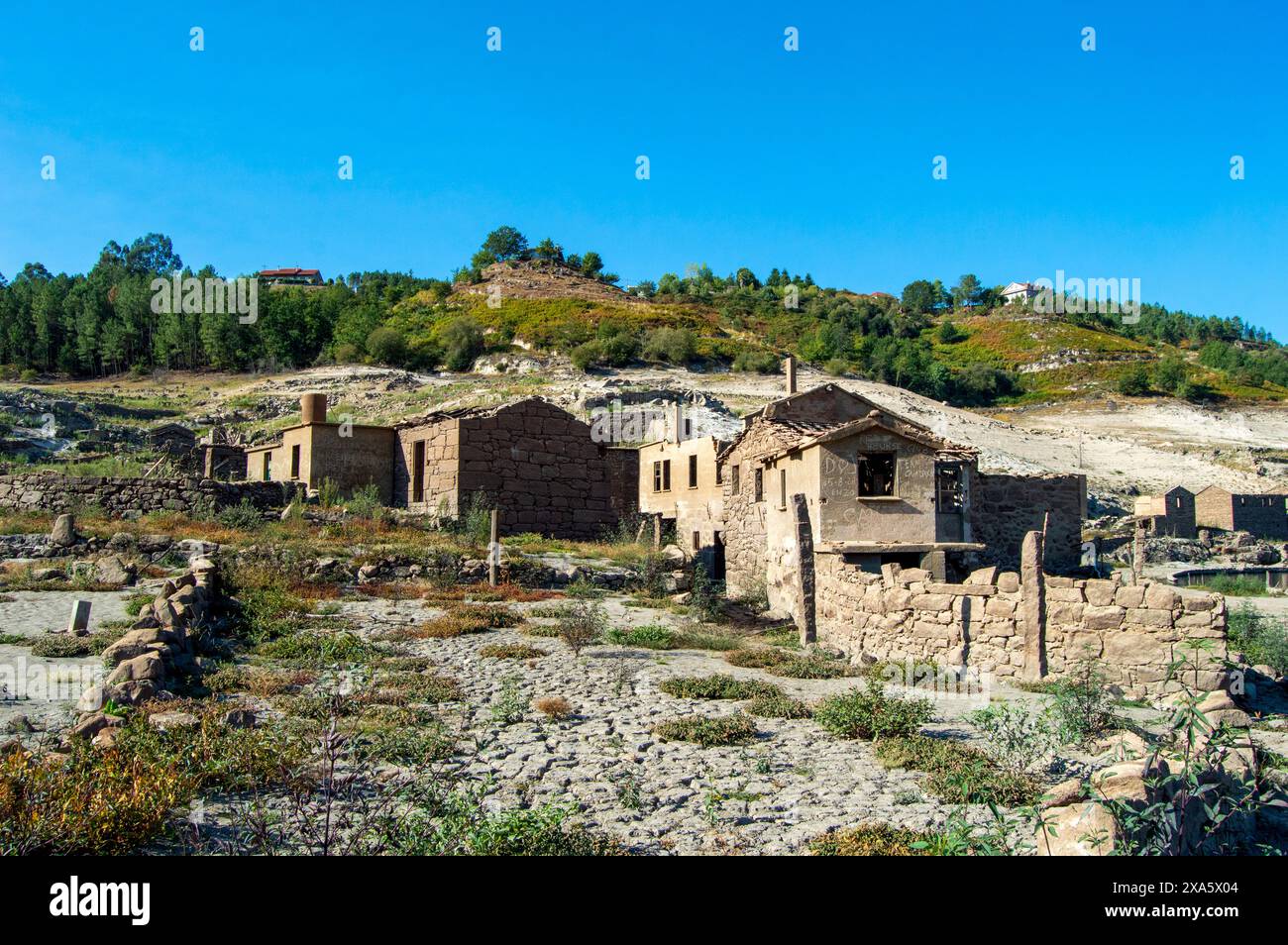 Rustic stone building on hillside with forest background Stock Photo ...