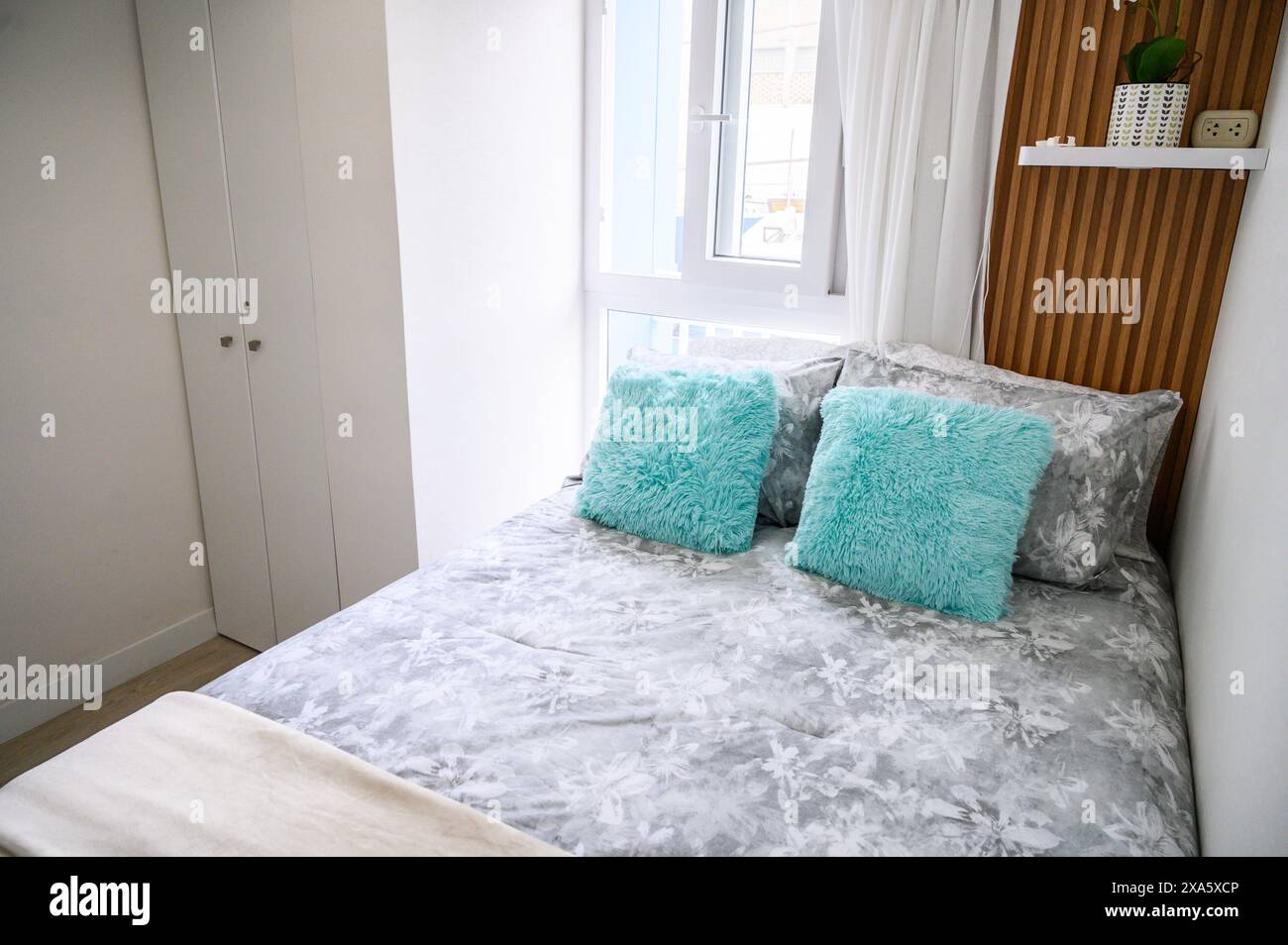 Bright and inviting bedroom space featuring a neatly made bed with ...