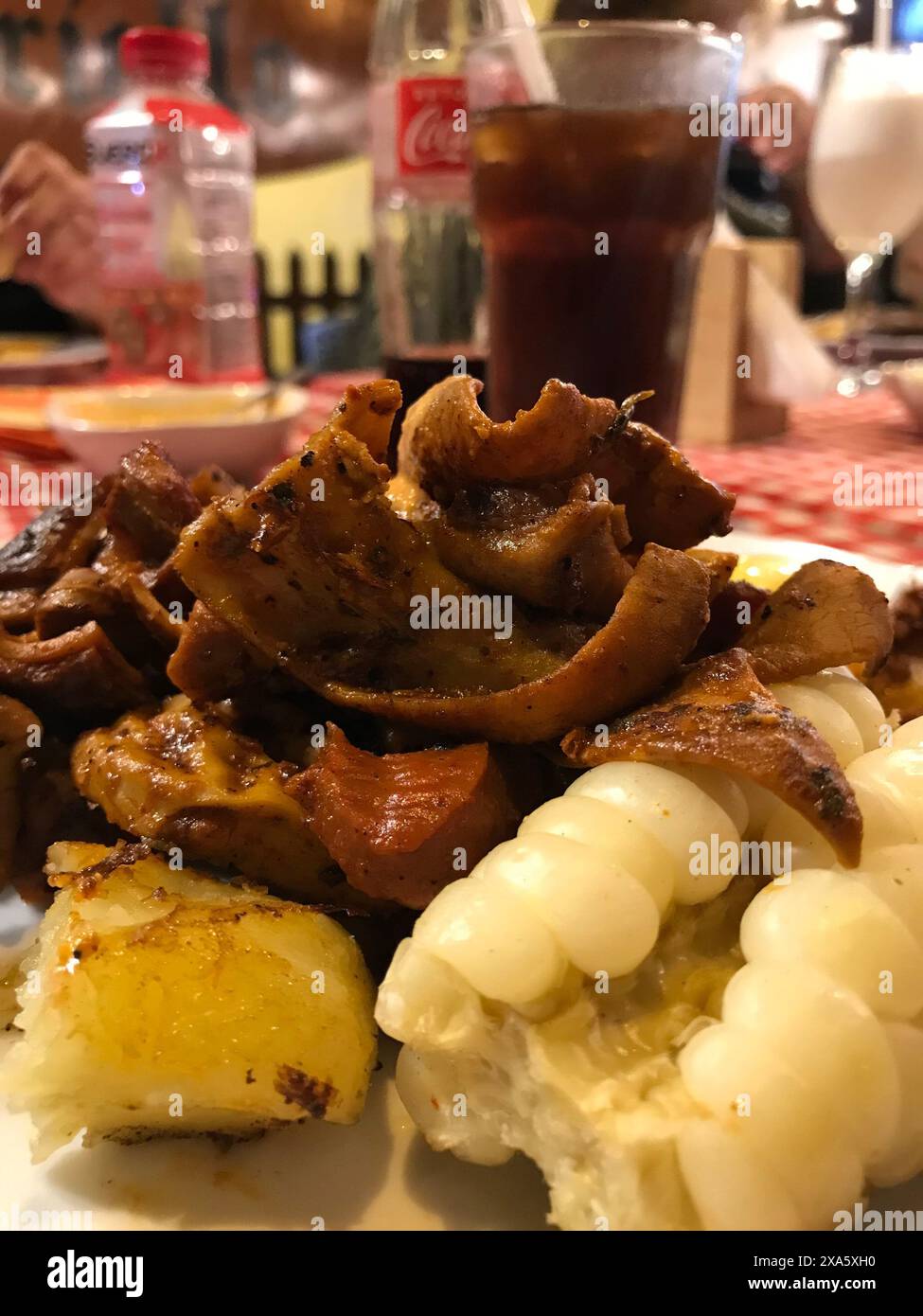 Close-up of a flavorful peruvian dish featuring grilled anticuchos and ...