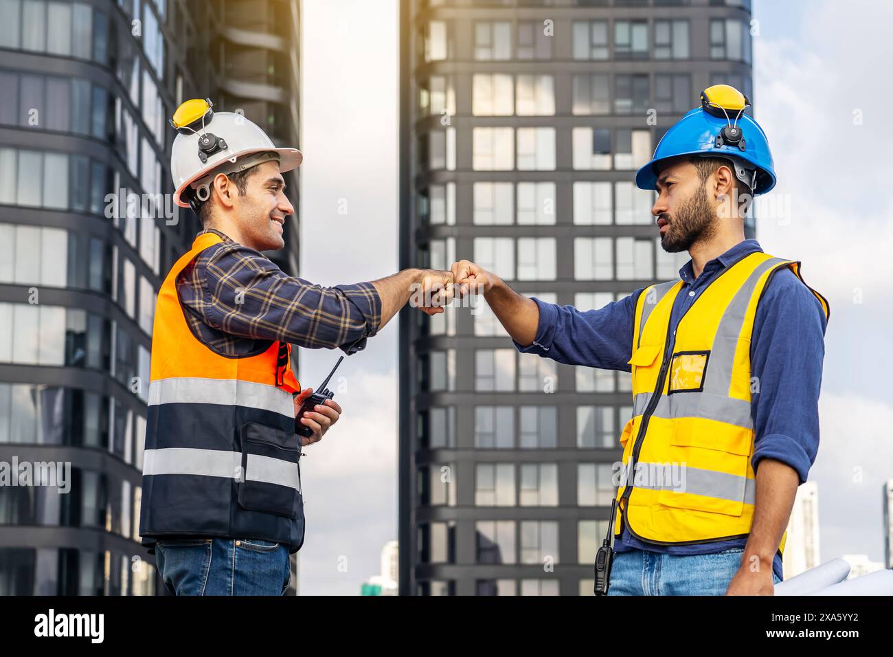 The construction workers shaking hands atop a building in Thailand ...