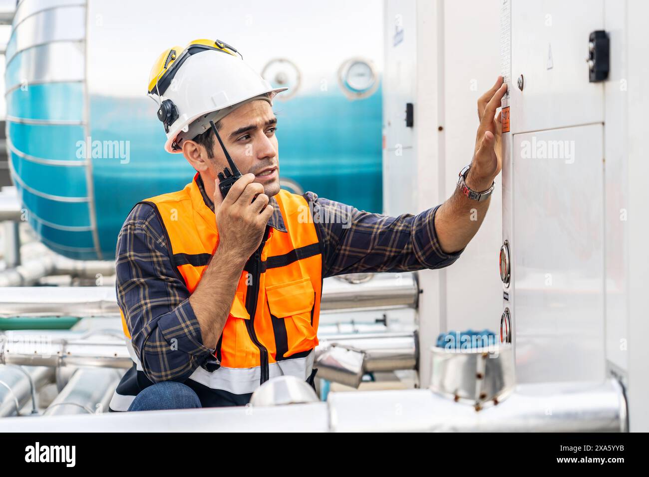 A technical foreman chatting on radio about building systems maintenance in Thailand, Bangkok ...
