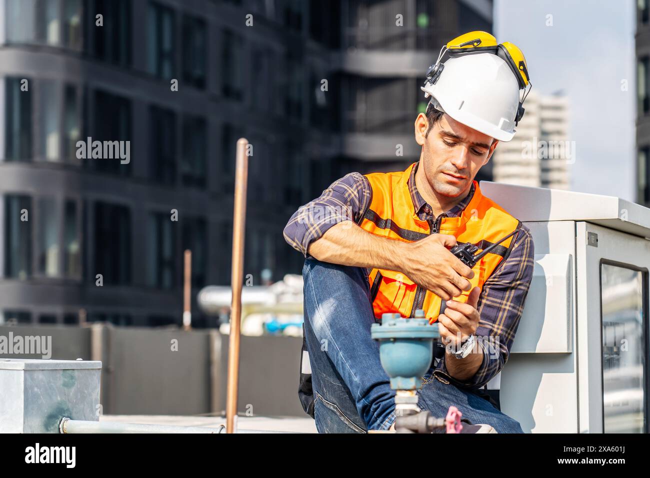 A technical foreman chatting on radio about building systems maintenance in Thailand, Bangkok ...