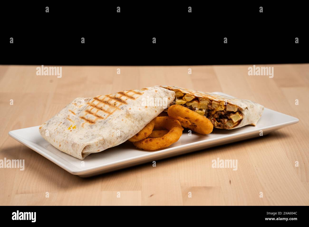 A close-up of a flatbread burrito with onion rings Stock Photo - Alamy
