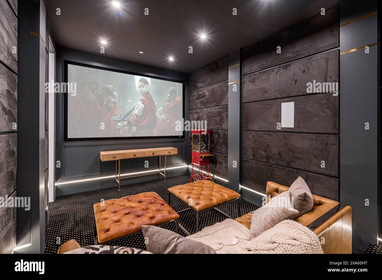 The Brown leather couches in a private cinema with Money Heist on the screen Stock Photo - Alamy