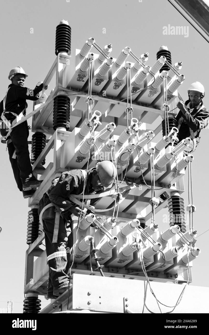 Two linemen repair a power transformer together Stock Photo - Alamy