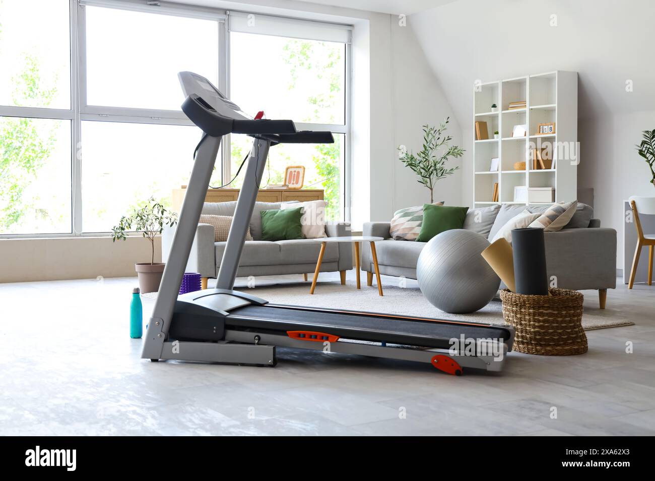 Modern treadmill with sports equipment in living room interior Stock ...