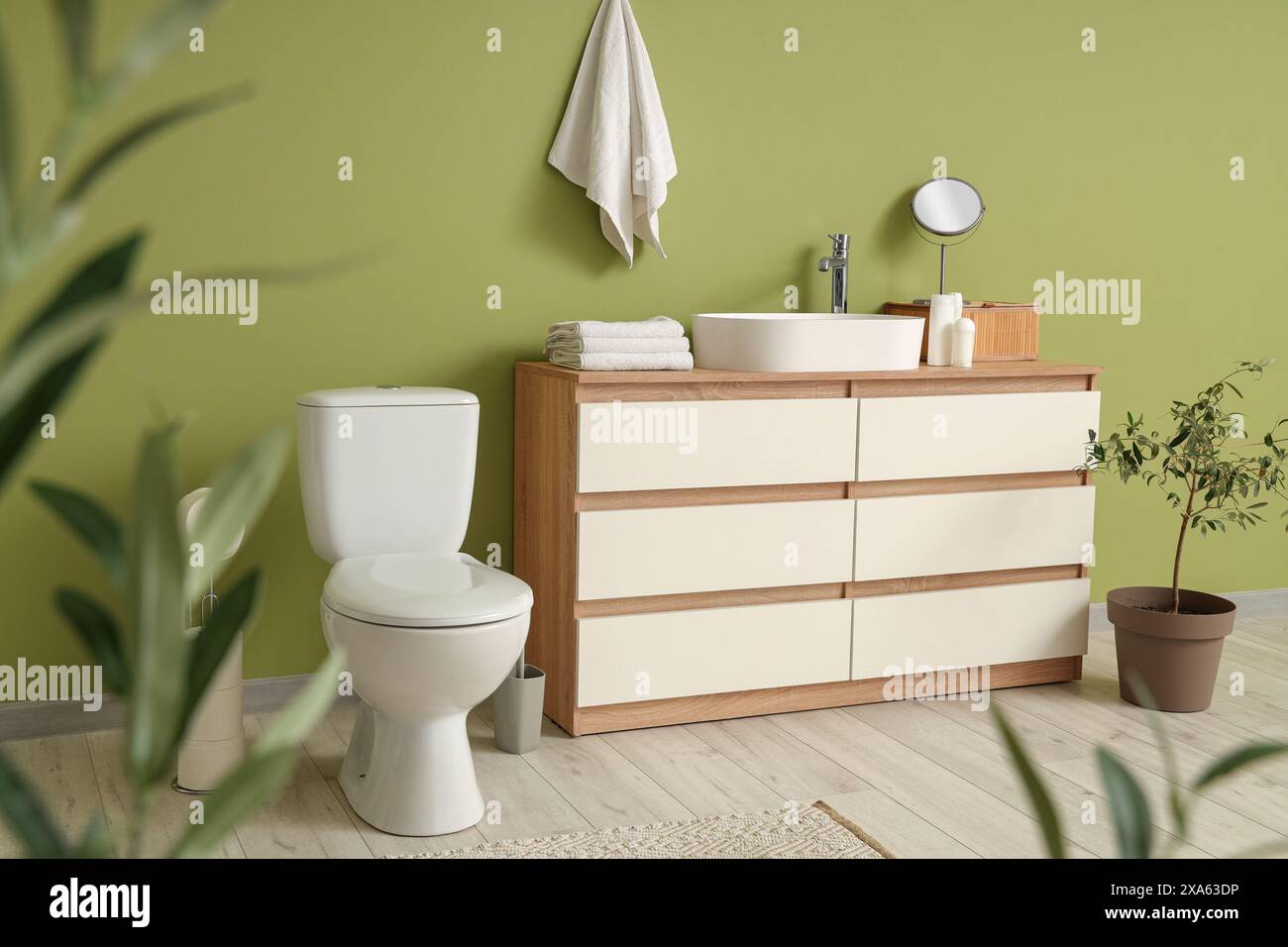Interior of modern bathroom with big commode, toilet bowl and ...