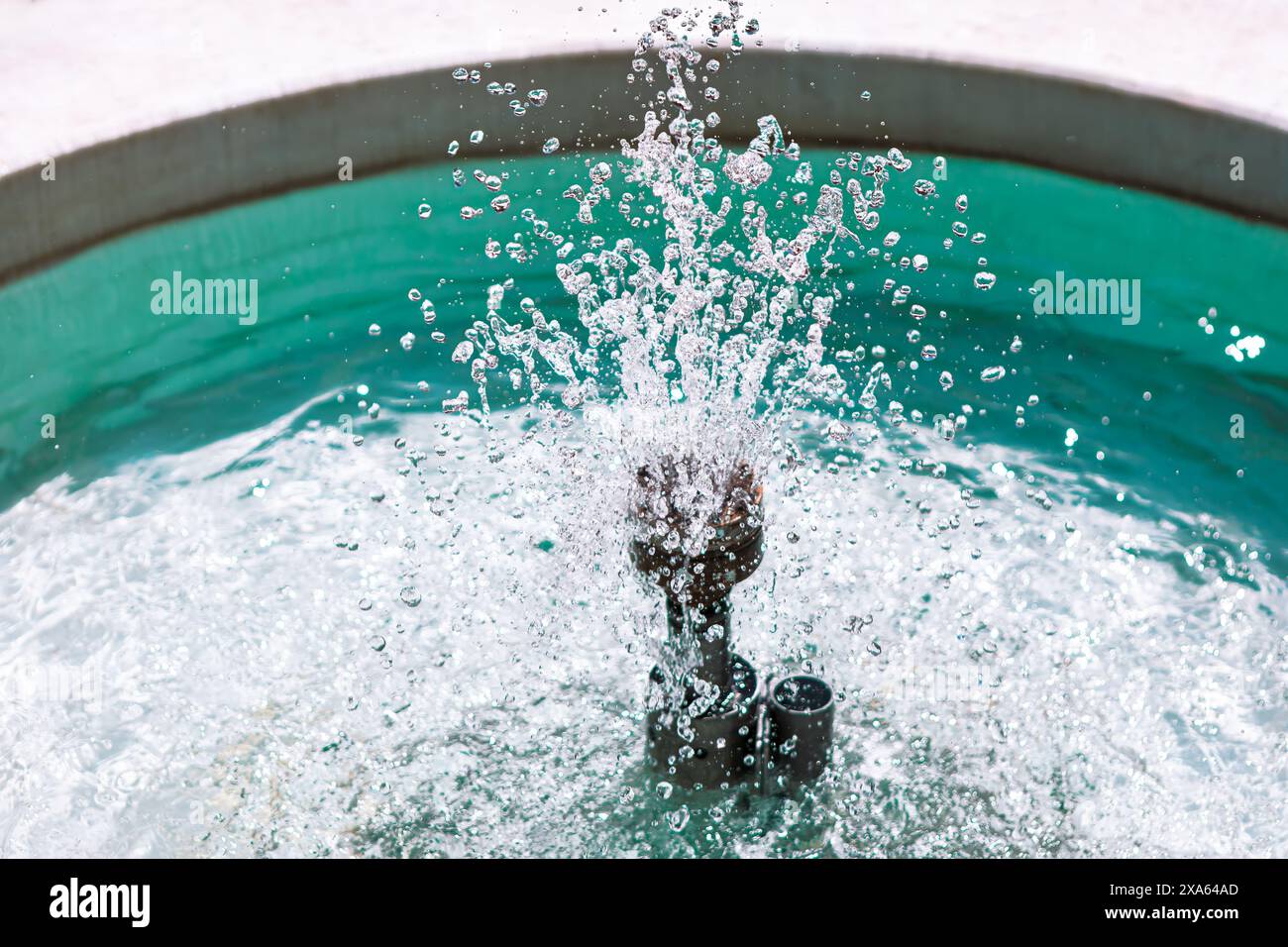 Fountain splashing in pool creating a cascading water Stock Photo - Alamy