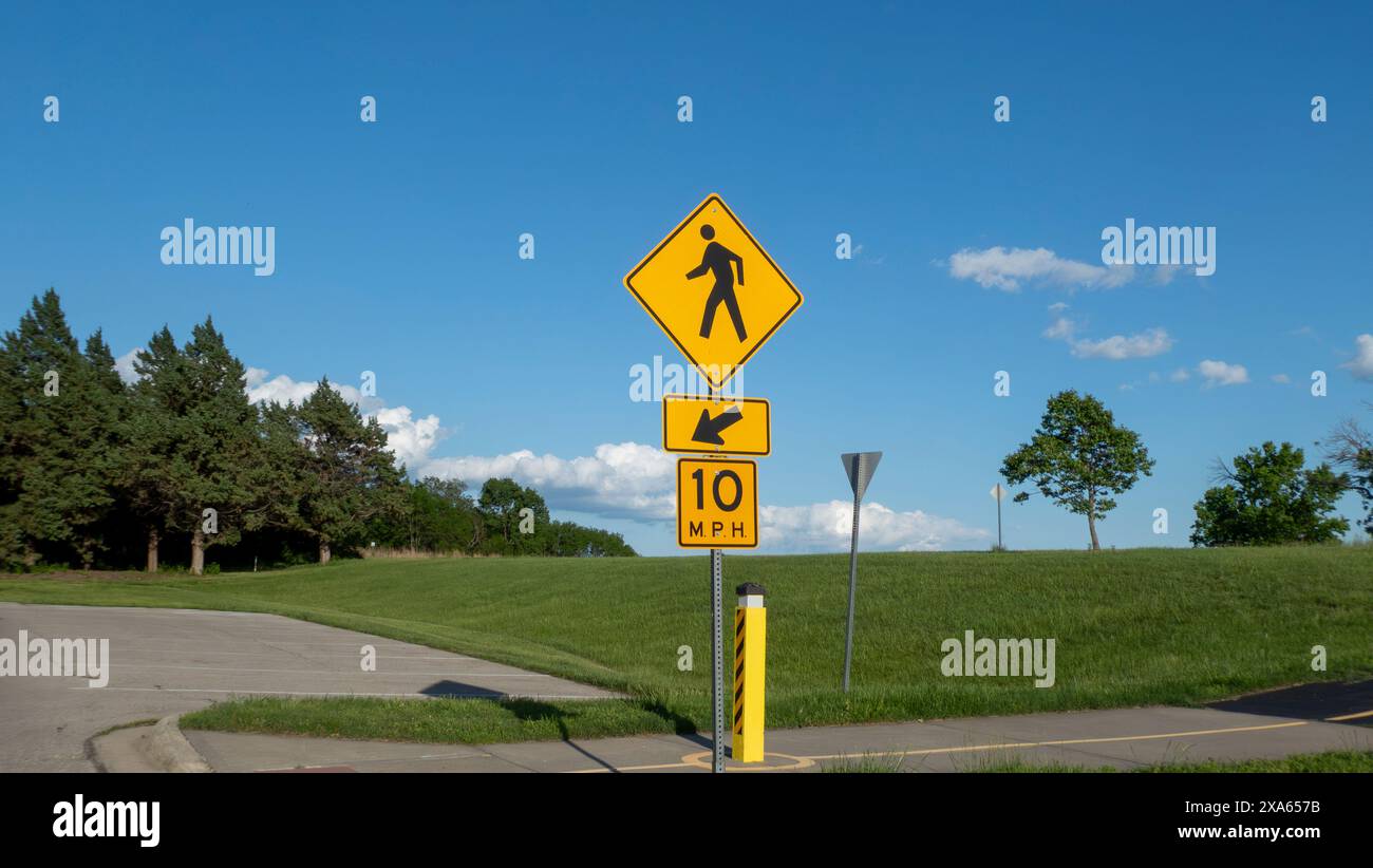 Two road signs in the center of a street, one for pedestrians Stock ...