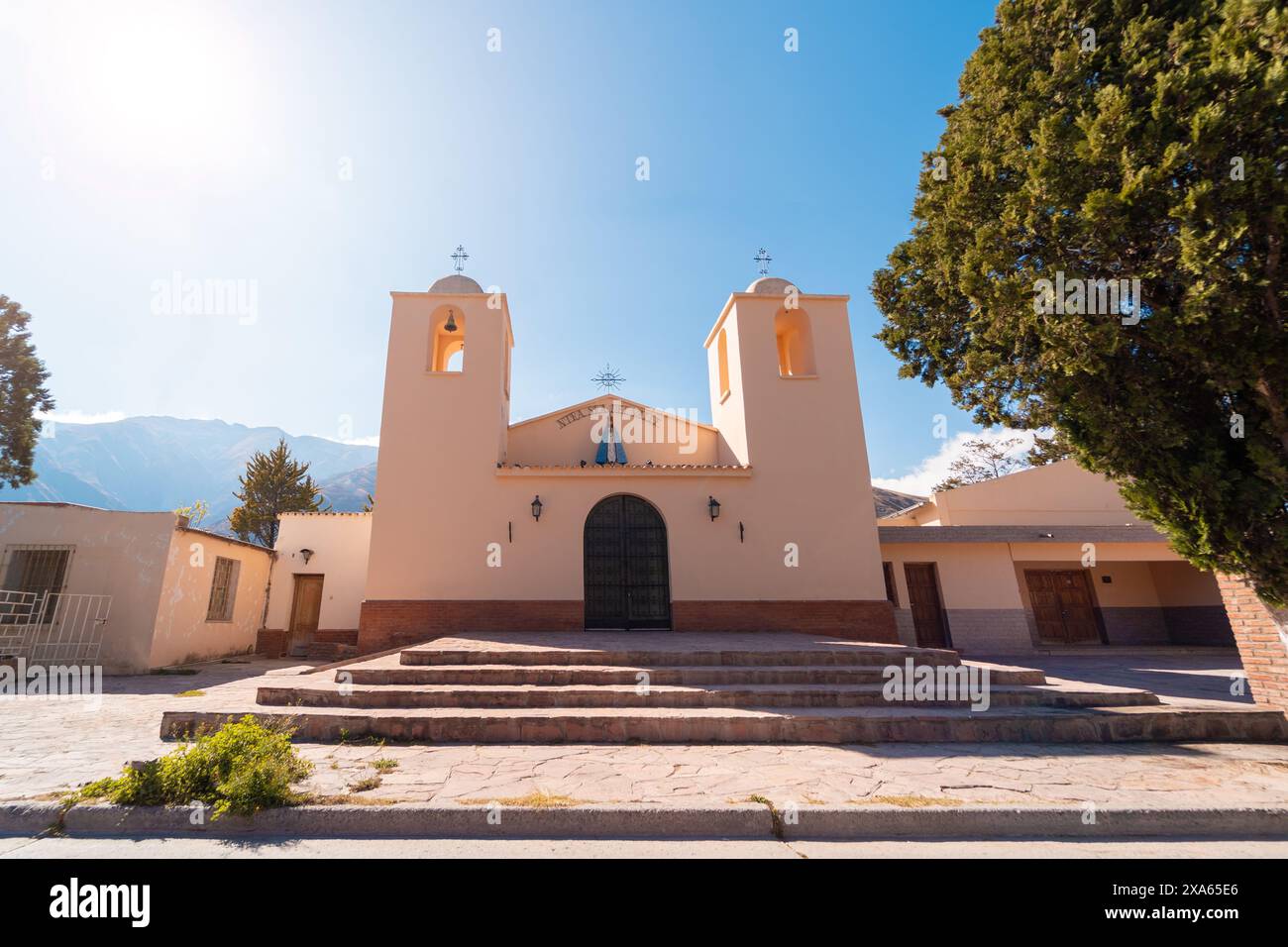 An old stone church building with a tall spire sits in the center of a ...