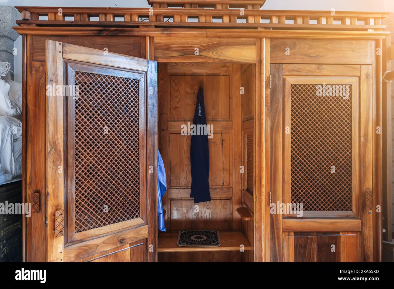 empty wooden catholic confessional with open door inside the interior ...