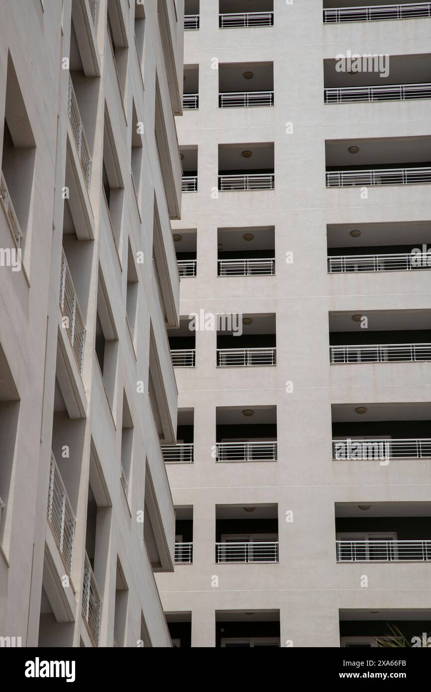 A tall grey building with balconies on every level Stock Photo - Alamy