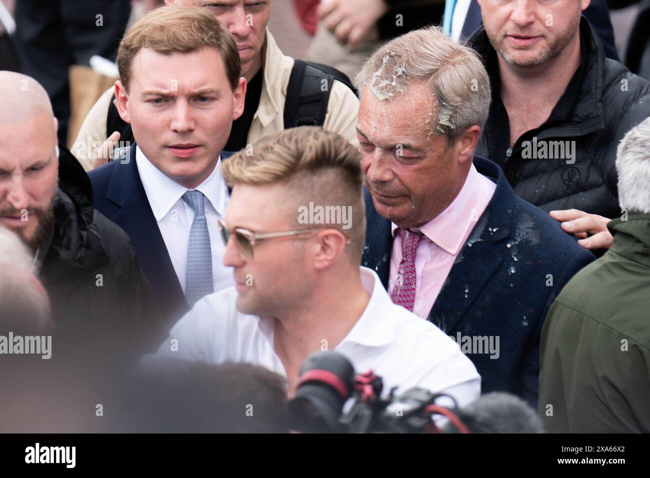 Leader of Reform UK Nigel Farage has a milkshake thrown over him as he ...
