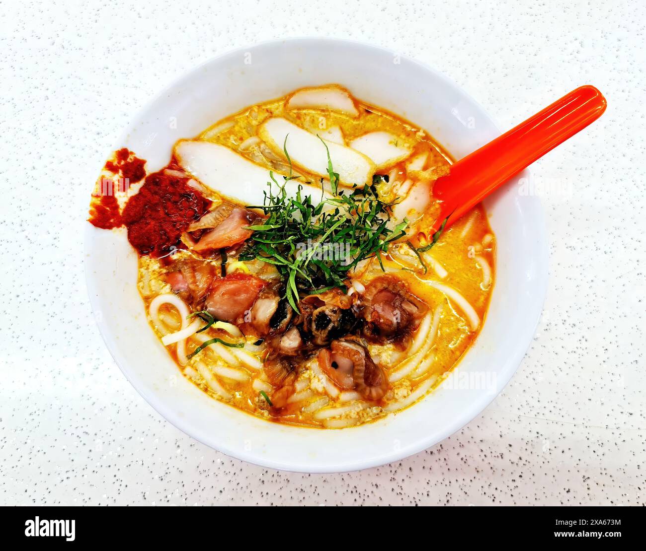 A top view of traditional Singapore Laksa with coconut milk and ...