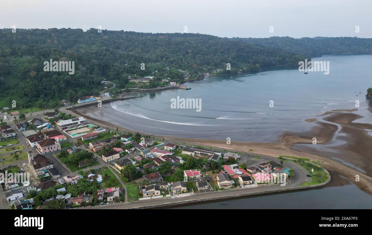 A scenic waterfront with a sandy beach and numerous adjacent buildings ...