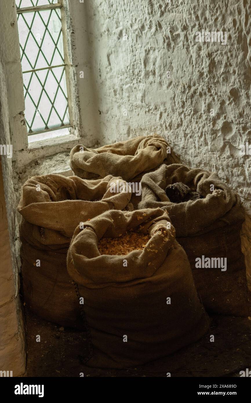 A vertical of old sacks at the window in Bunratty Castle Stock Photo ...