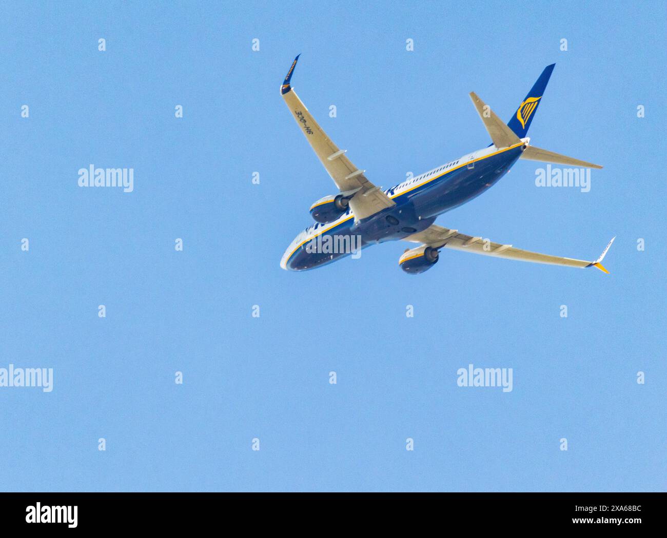 A blue and white jet soaring in clear blue skies, in Sofia, Bulgaria ...