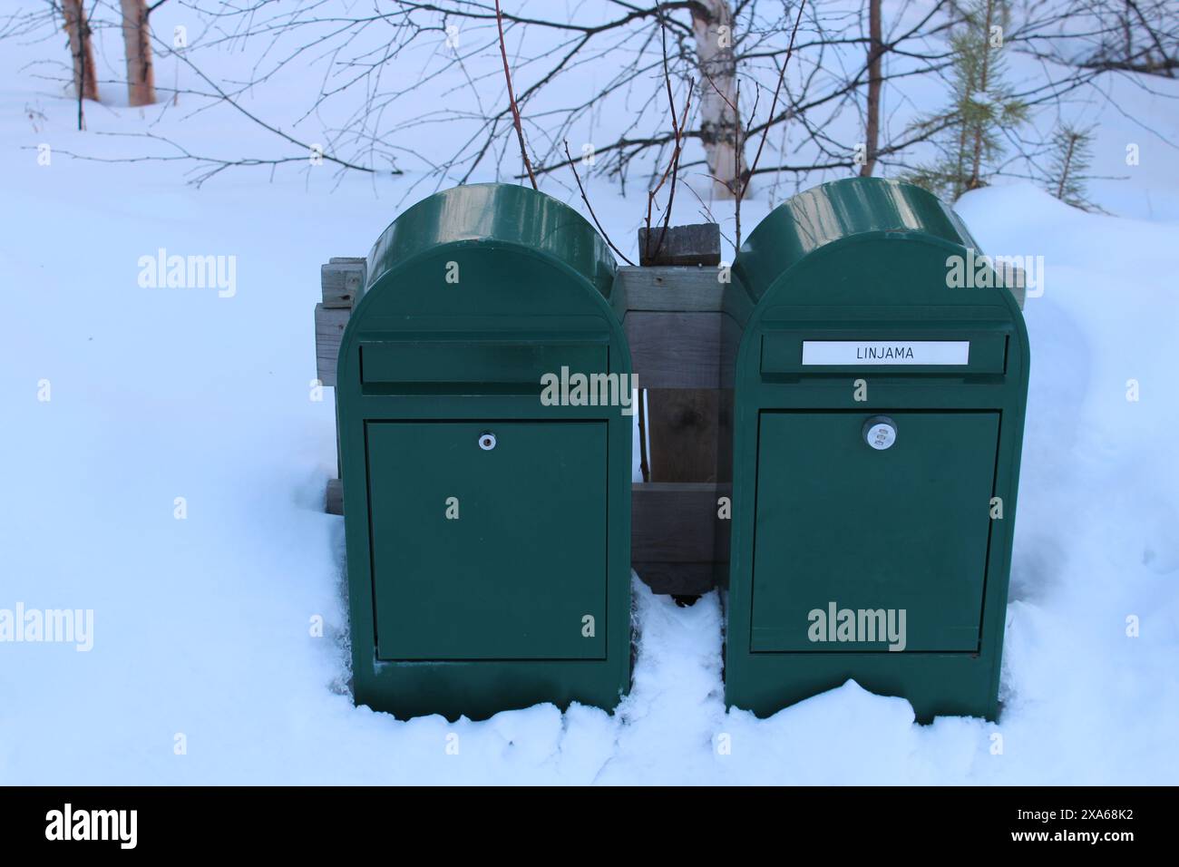 The two green mailboxes standing side by side in snowy weather Stock ...