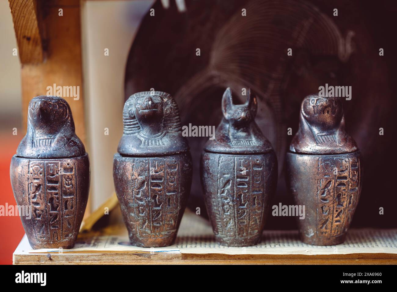 Egyptian set with three urns and four lids showcased Stock Photo - Alamy