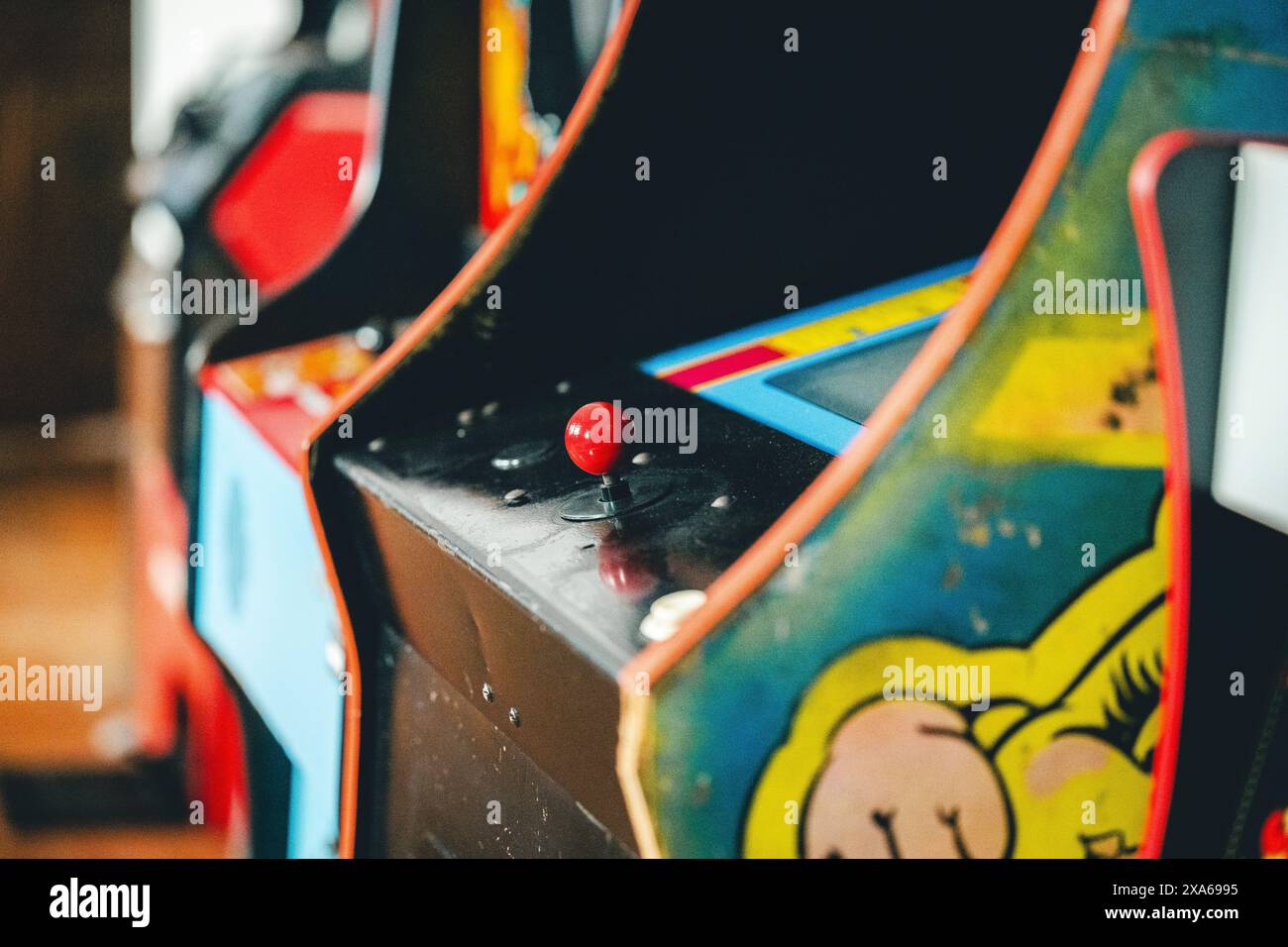 Three arcade games, one with red knobs and another in black color Stock ...