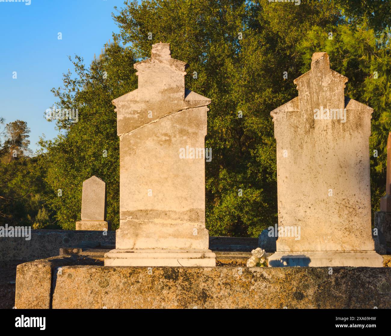 The ancient stone headstones aligned in a graveyard Stock Photo - Alamy