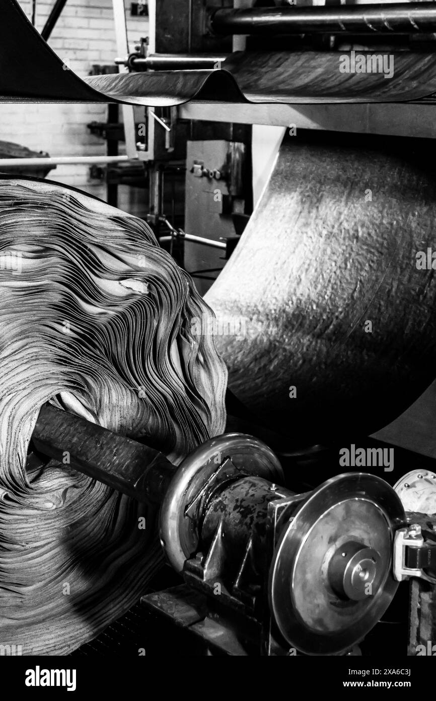 A close-up of rubber roll on conveyor belt machinery at a factory in ...