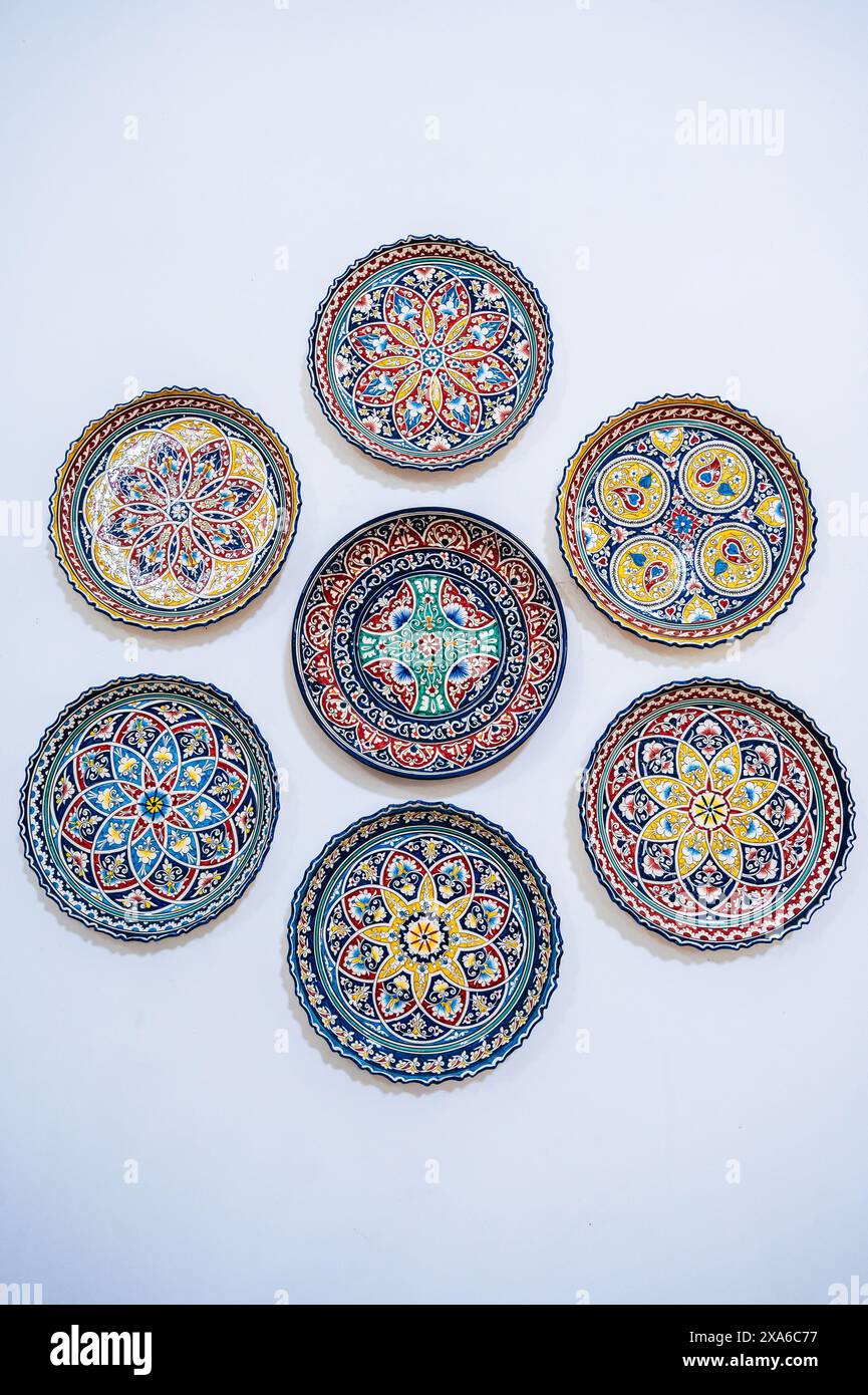 traditional Uzbek ceramic plates hand-painted on white wall at the ...