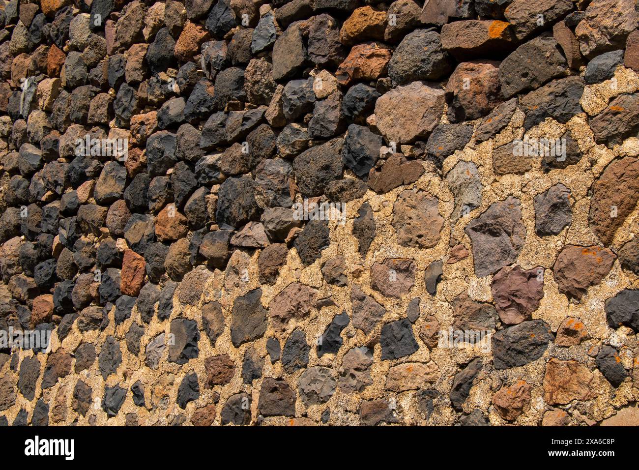 A wall with embedded rocks and gravel texture Stock Photo - Alamy