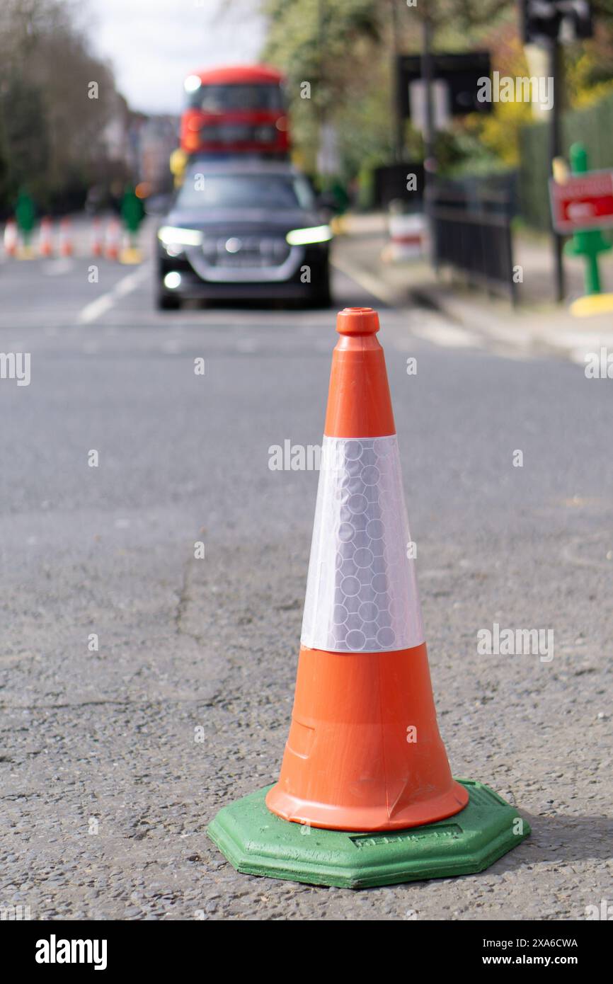 A typical street scene in London, focusing on a traffic cone used for ...