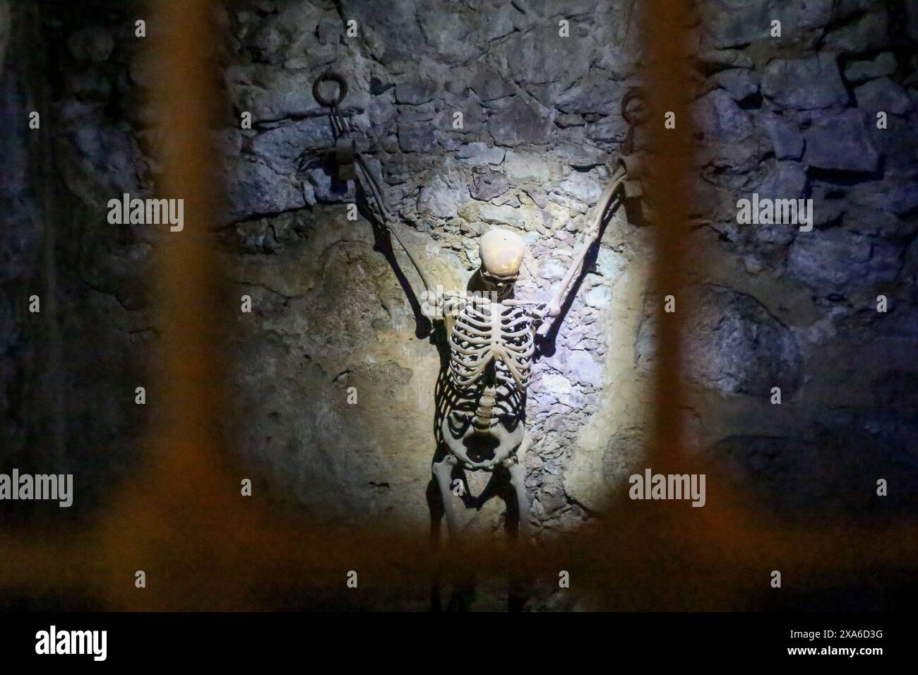 A skeleton embedded in stone wall near gate and window Stock Photo - Alamy