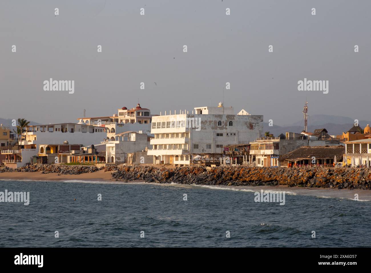 Some houses on beachfront by water near shore Stock Photo - Alamy