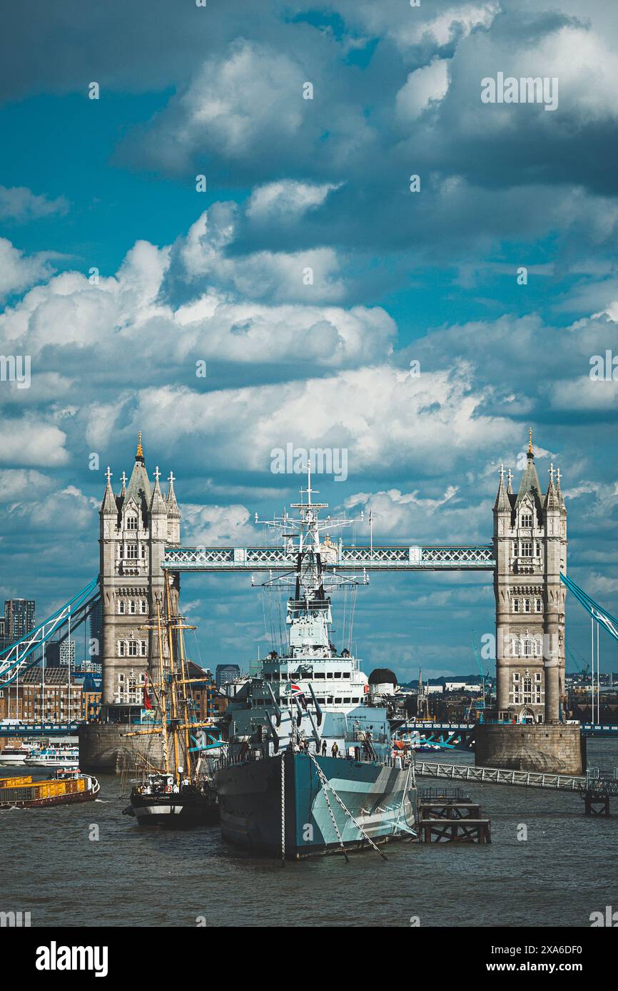 The HMS Belfast town-class light cruiser with the Tower Bridge in the ...