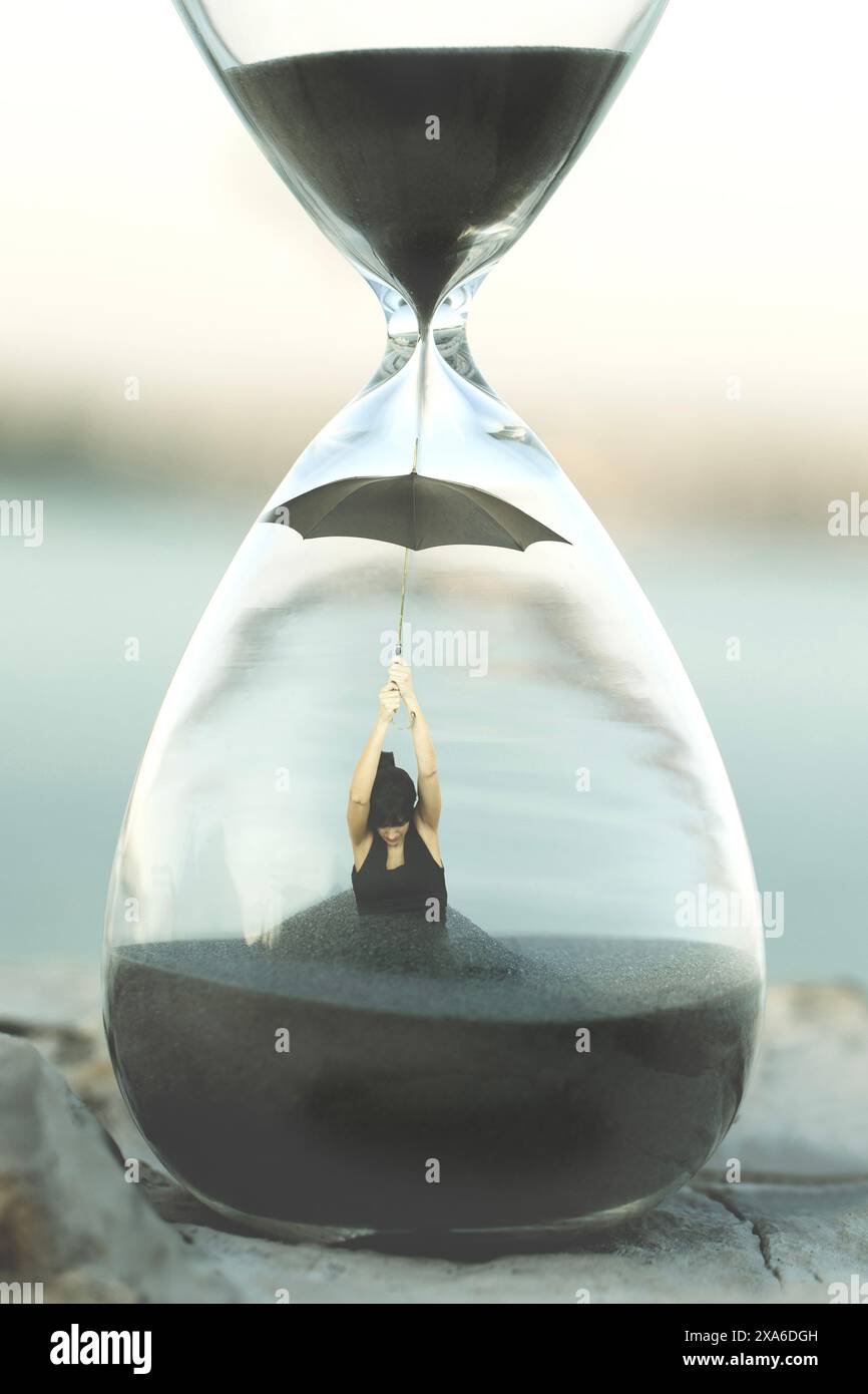 surreal woman with umbrella inside an hourglass protecting herself from ...