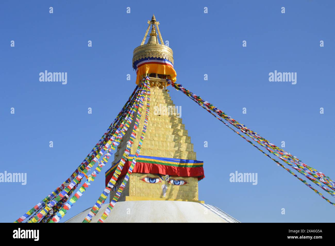 Top part of Boudhanath Stupa or Chaitya adorned with colorful prayer ...