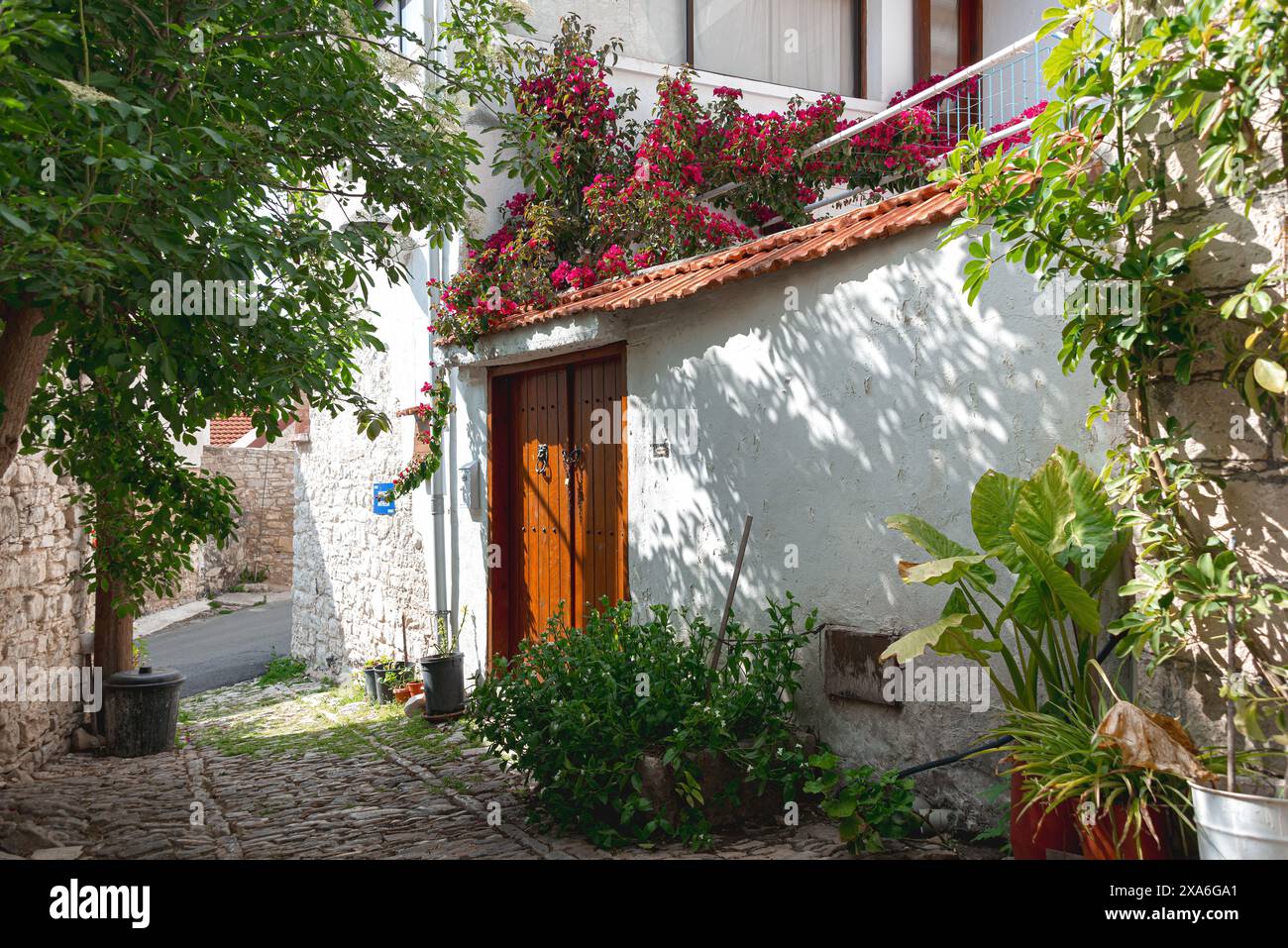 Quaint, sunlit alley featuring a traditional mediterranean village ...