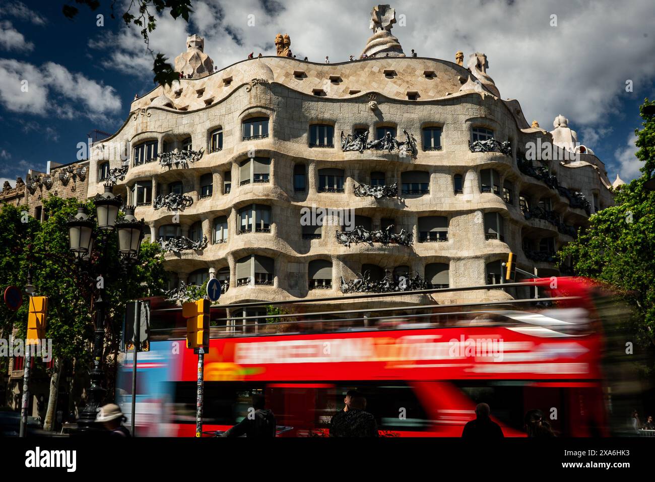 The Barcelona Gaudi building with people waiting to cross the road with ...